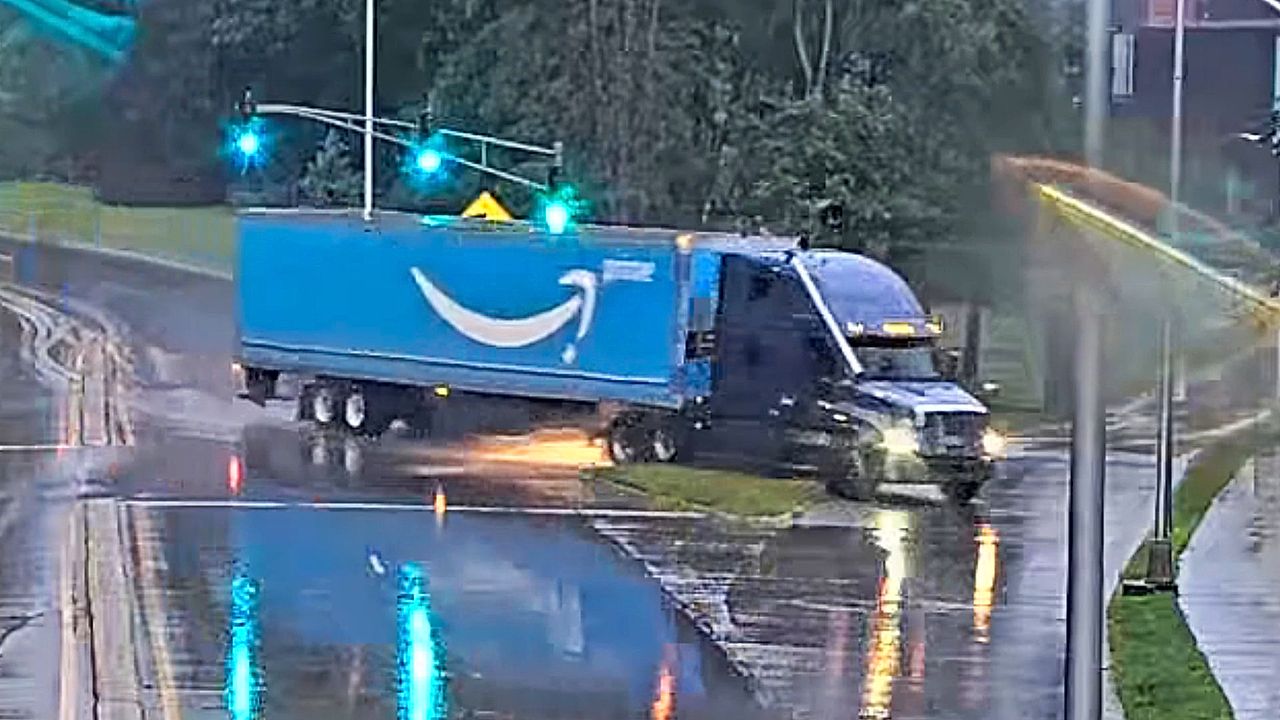 Amazon semitruck skids off wet road and nearly plunges into Iowa River