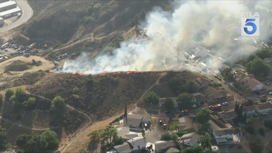 Crews battle fire burning near homes in Pacoima
