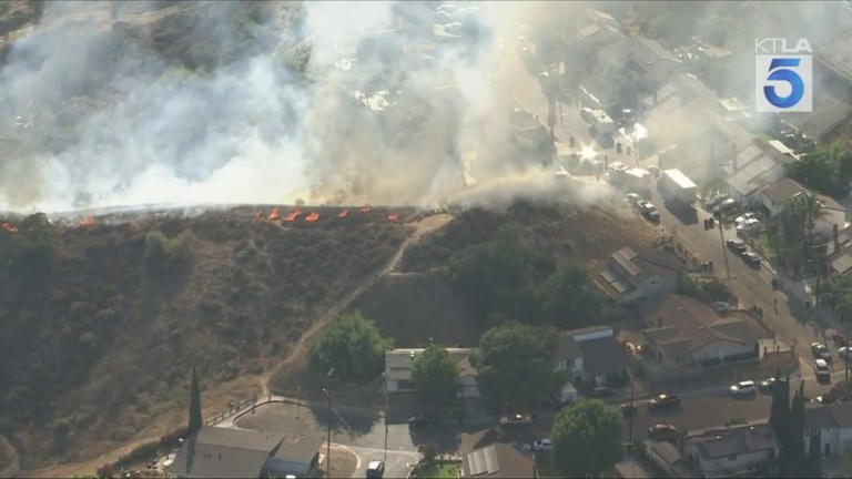 Crews battle fire burning near homes in Pacoima