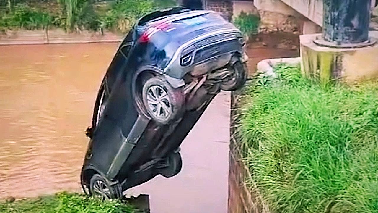Car dangles on two wheels above river after near-plunge in China
