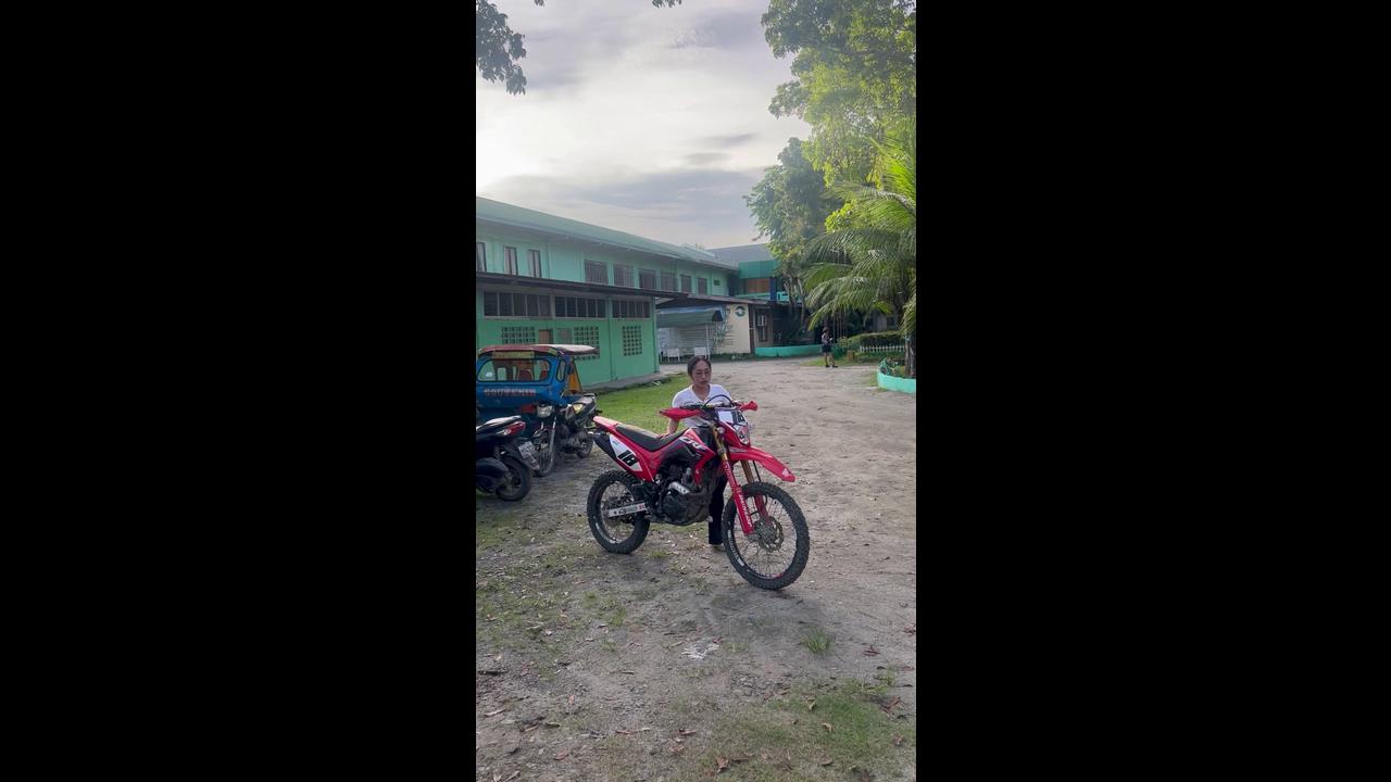 Impressive moment petite rider effortlessly manoeuvers off-road motorcycle