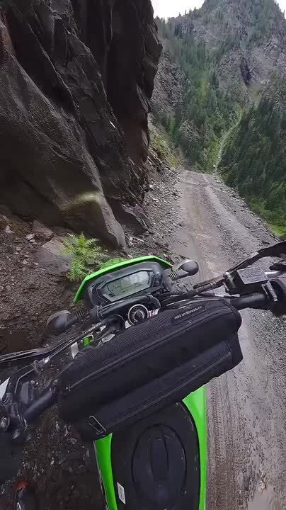 Off Road Motorcycle Nearly Skids Off Edge of Mountain