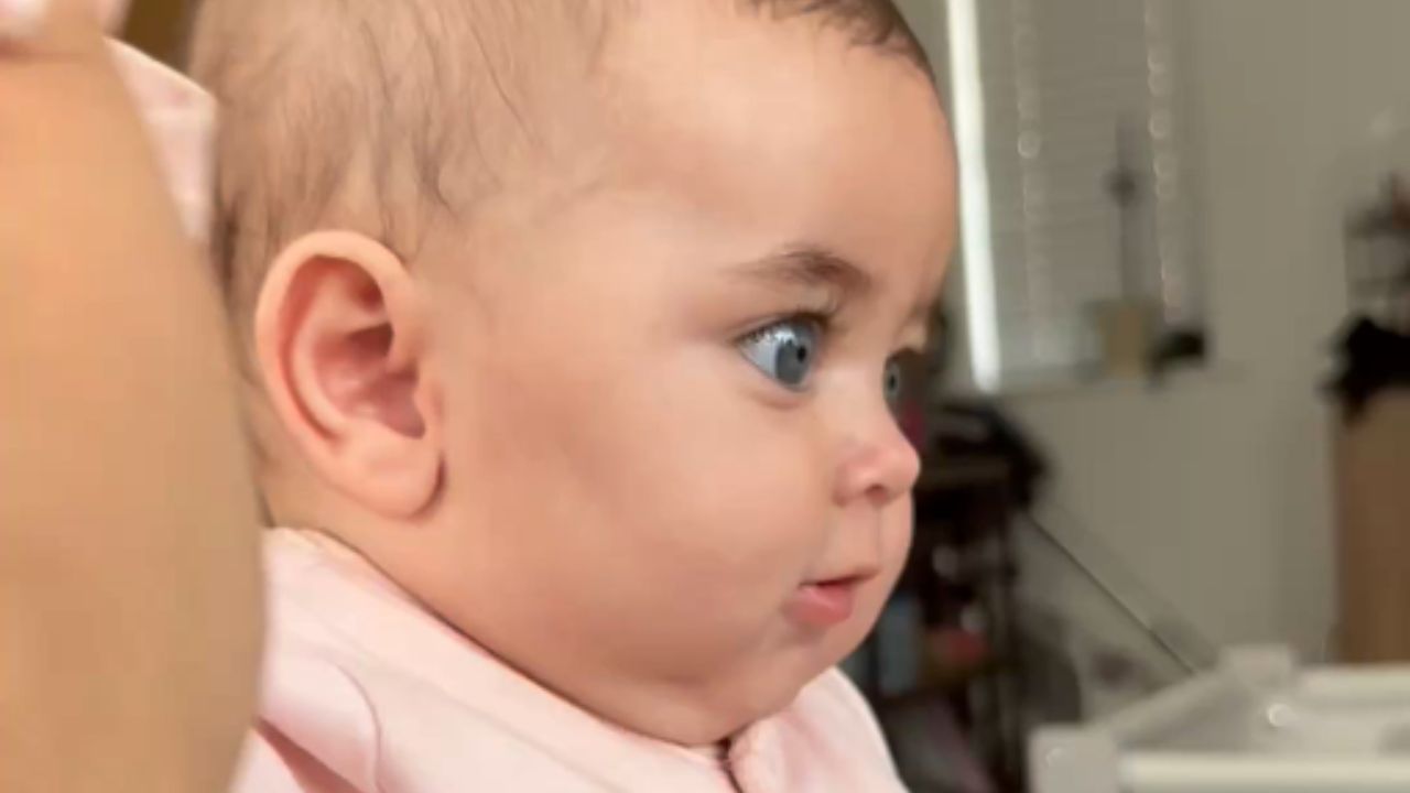 Baby girl watches her dance moves and goes into a blank stare