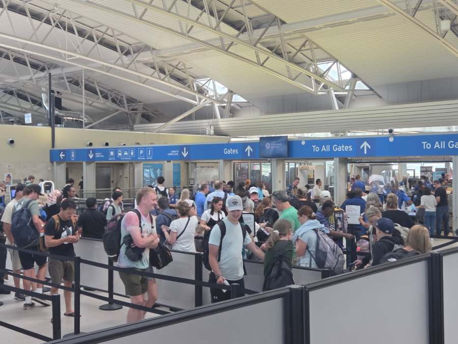 Lines extend outside Lambert Airport terminal as large St. Louis ...