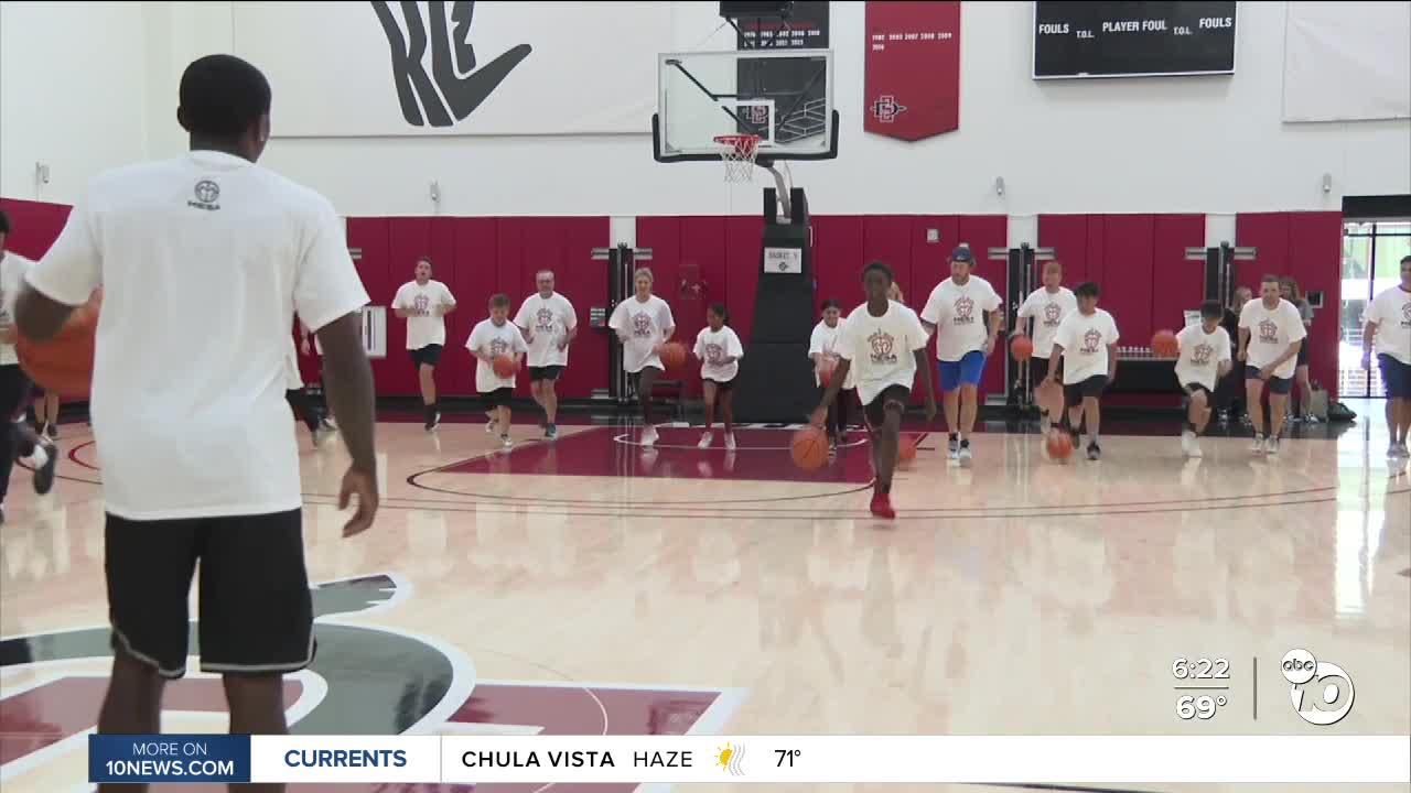 SDSU basketball team dribbles forward, builds up kids through mentorship