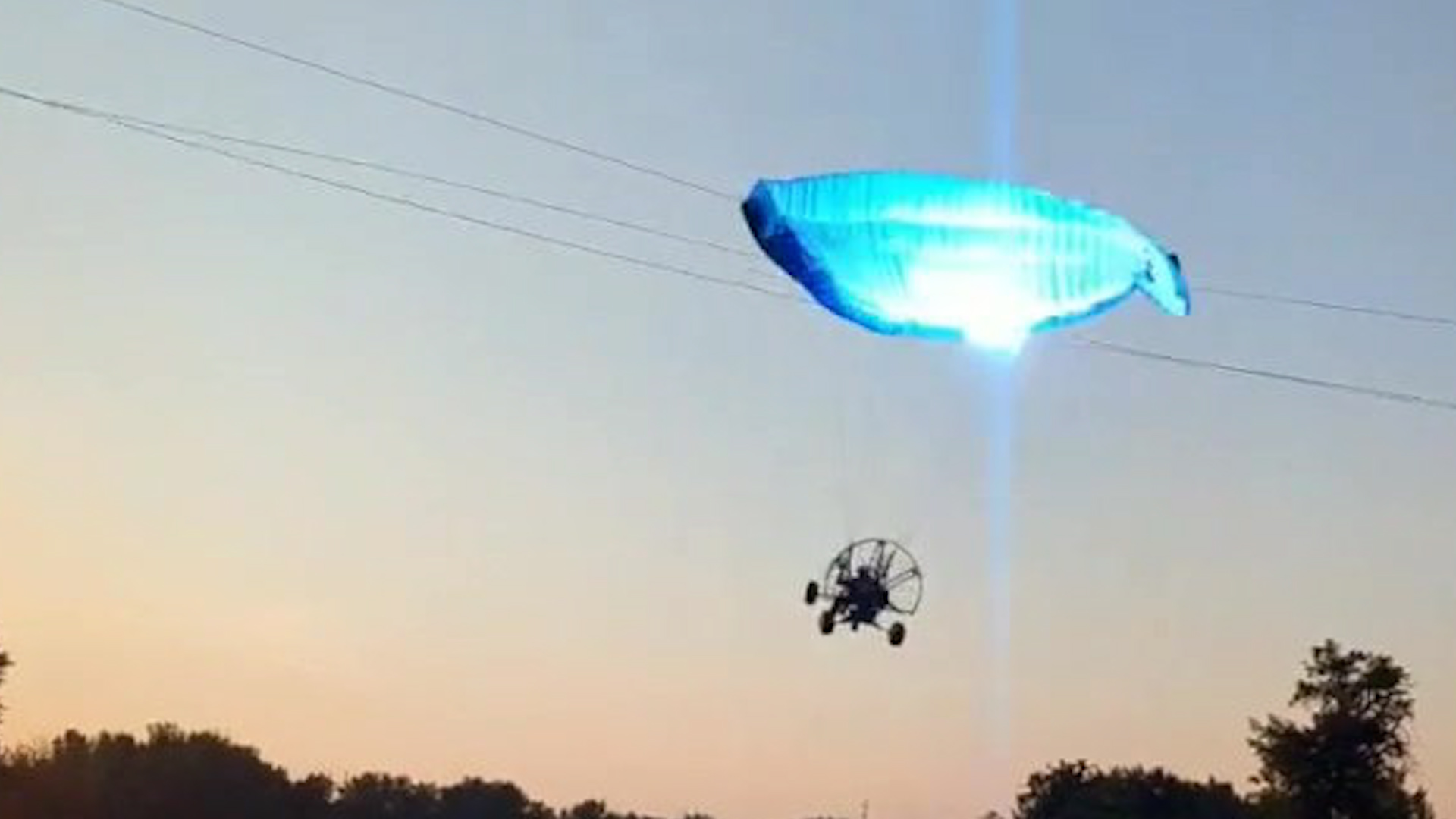 Paraglider hits power line and plummets into river