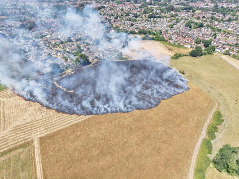 Shocking photos show raging field fire move towards homes – and its ...