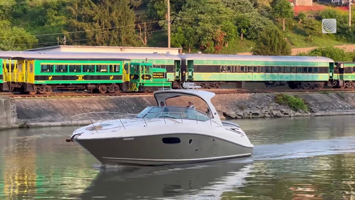 The drawbridge in Port Stanley goes up to allow this speed boat access ...