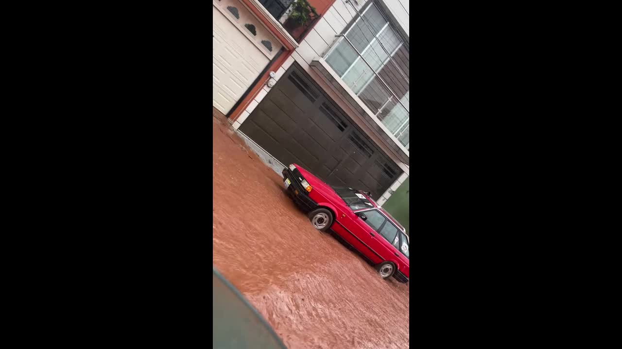 Truck splash soaks car through open window during road flood in ...