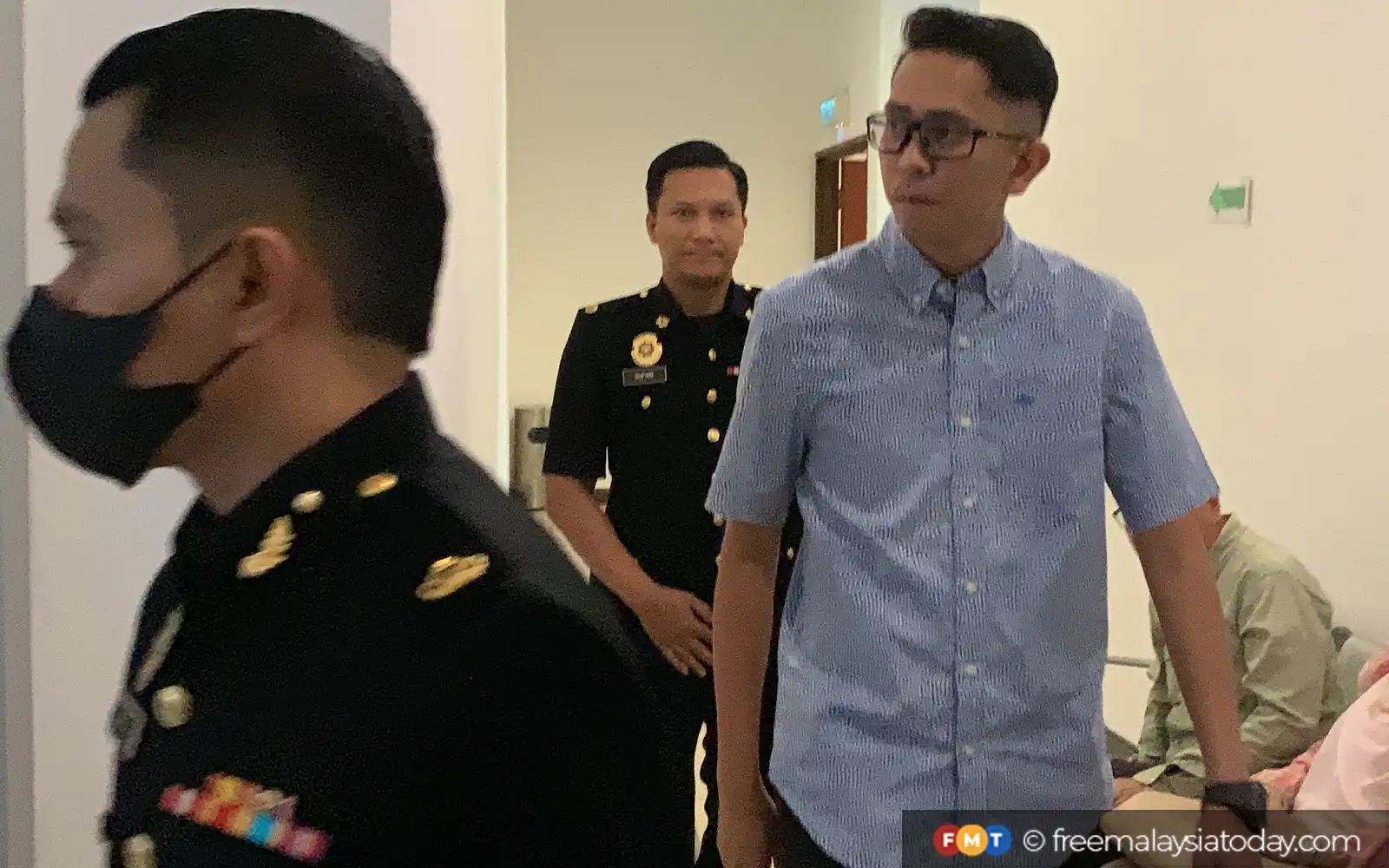 Immigration officer claims trial to 5 money laundering charges