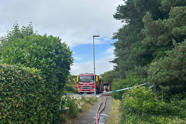 Police and firefighters at scene of house fire in Warrington