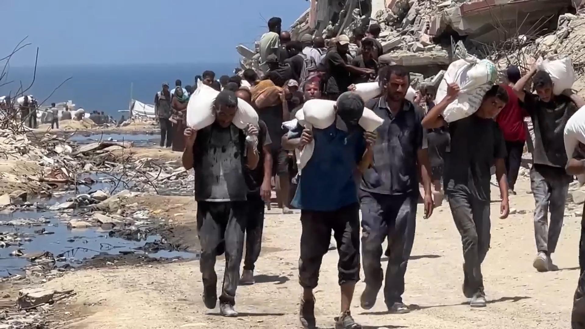 Palestinians gather along coastal road hoping to get food, but many ...