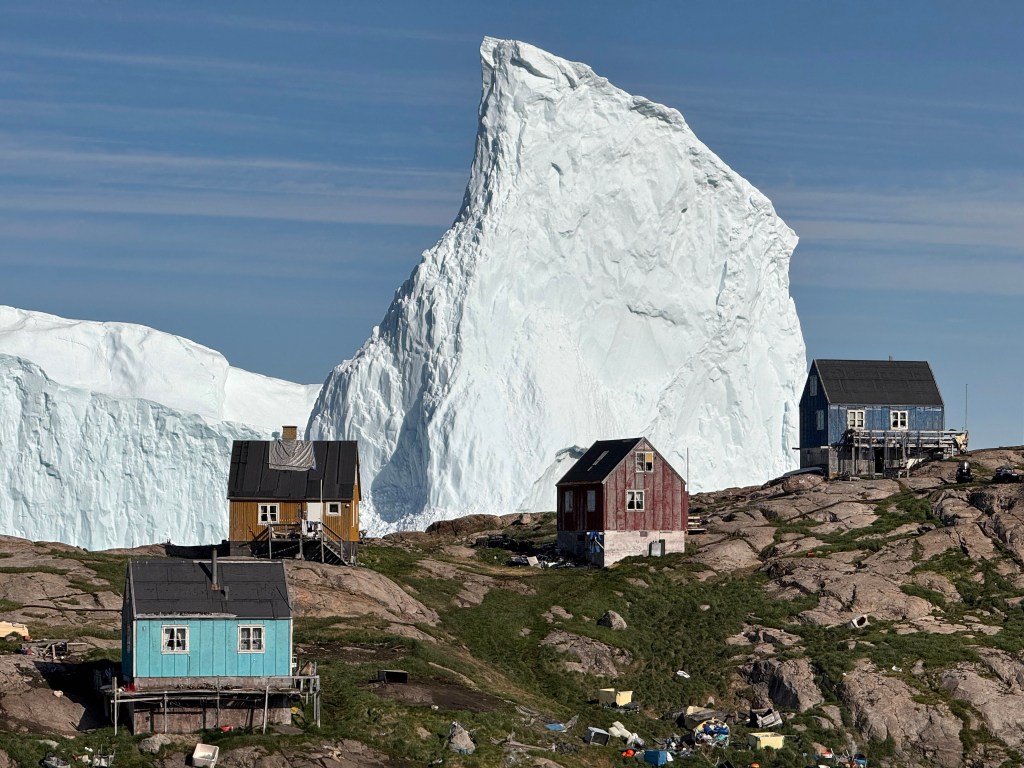 Incredible photos show huge iceberg drifting dangerously close to shore