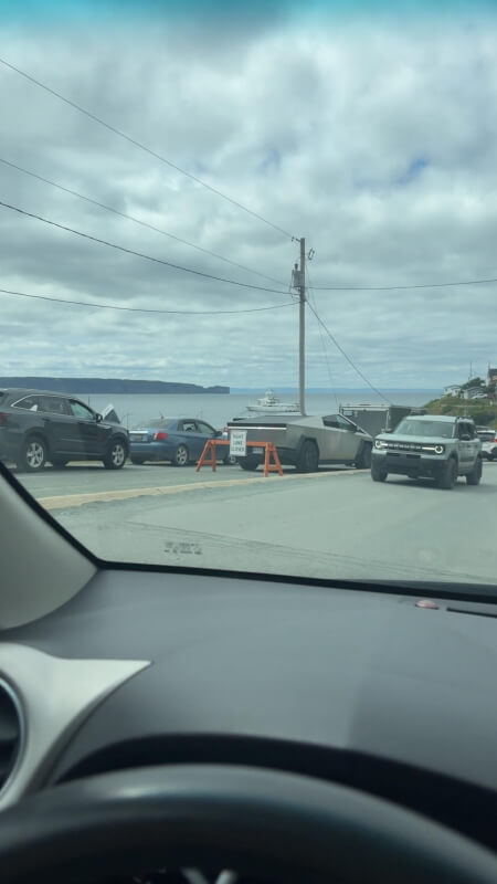 Photo of Tesla Cybertruck and massive vessel parked in local cove ...