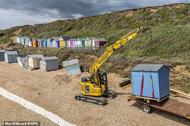 Local council removes £1million cliffside beach huts at risk of falling ...