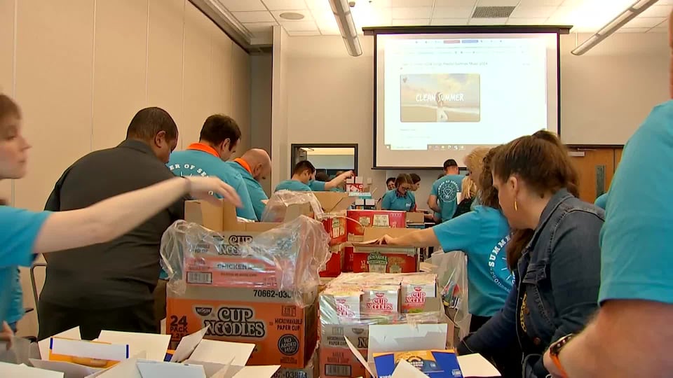 Local volunteers pack snacks to combat child food insecurity during summer
