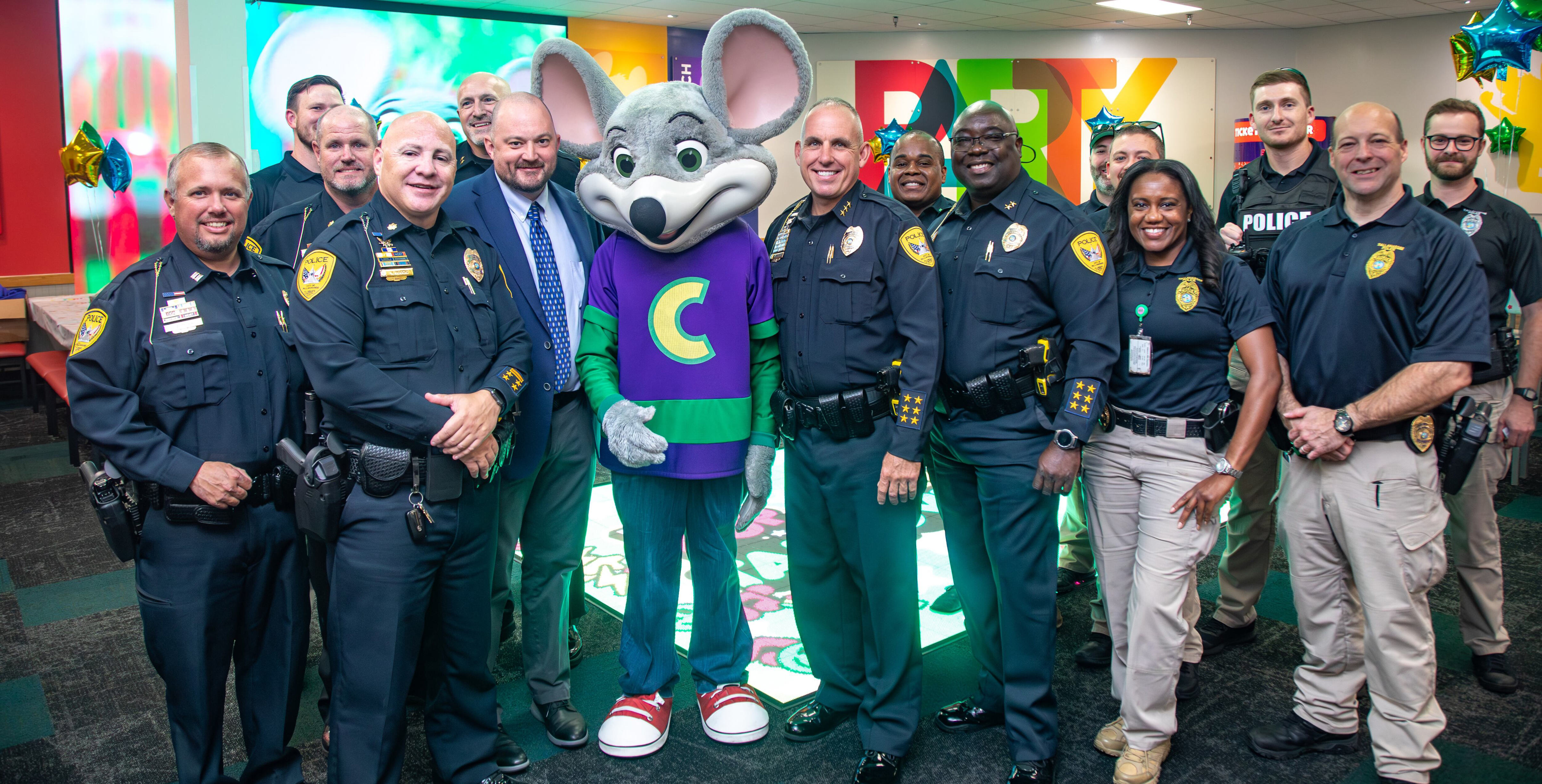 Mouse and police cheese for the camera as TPD and Chuck E. make amends ...