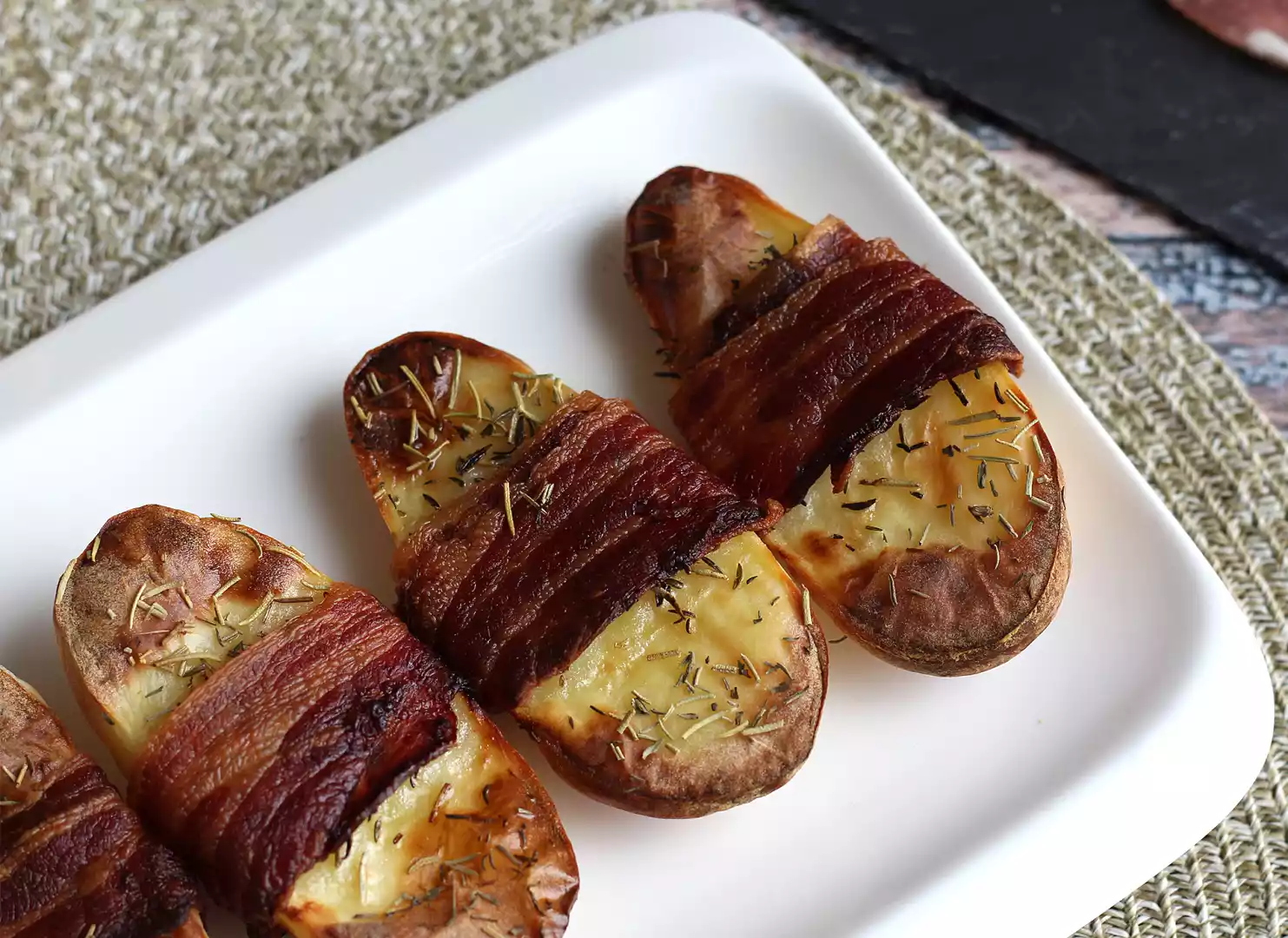 Baked potatoes coated with bacon