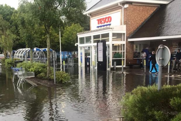 Water pours into Tesco after thunderstorm causes flooding