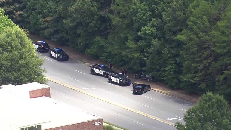 Large law enforcement scene along Woodruff Road
