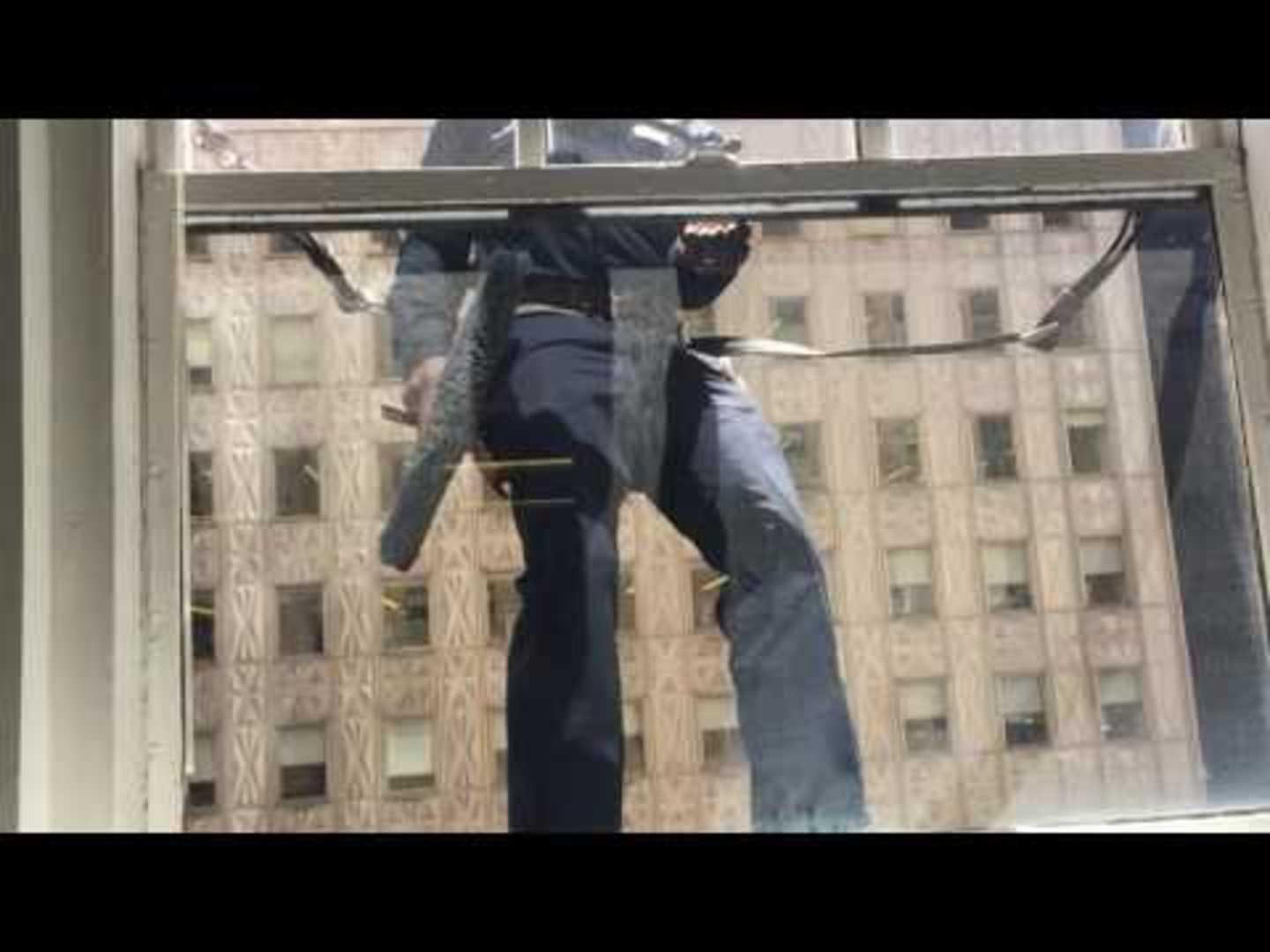 Man Cleans Dirty Window on 11th Story of Office Building