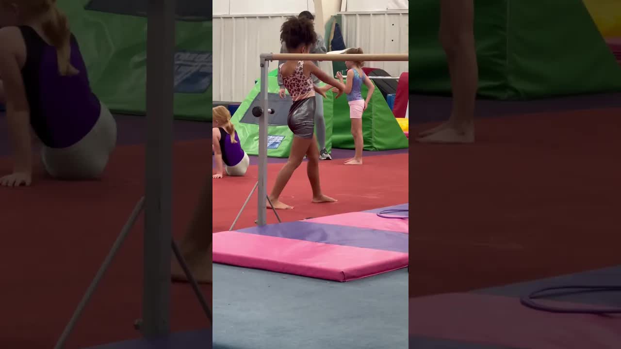 scarlett and tiania: scarlett gray practices hand placement on uneven bars