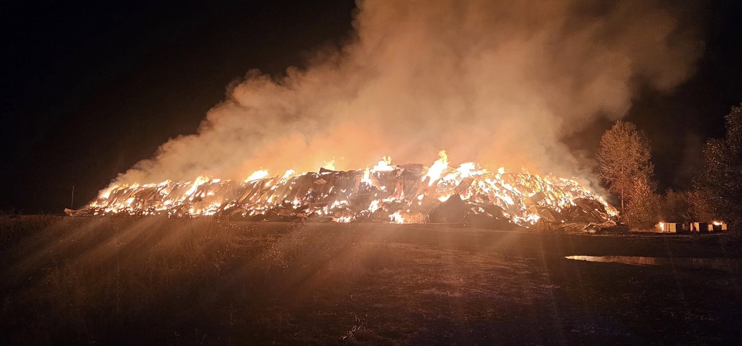 Multiple crews respond to large hay barn fire near I-5