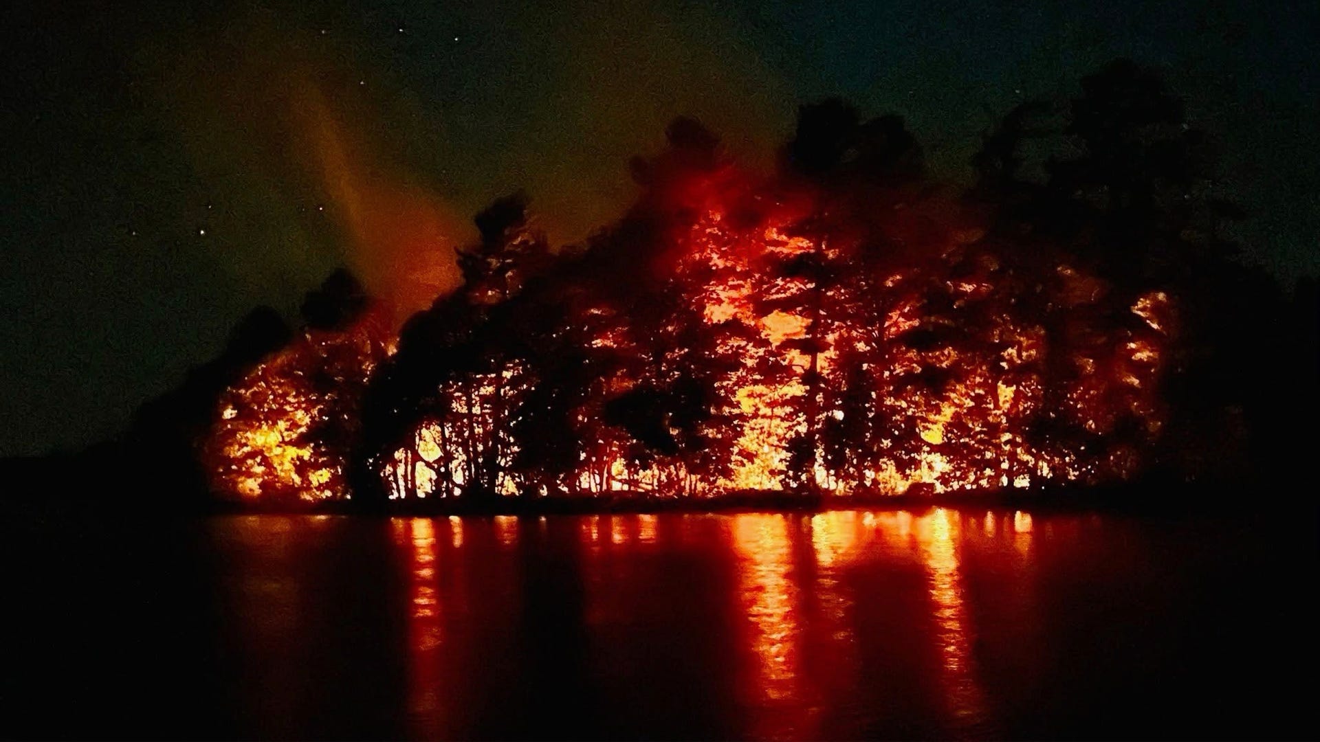 Fire will continue smoldering on island in Maine lake for several days