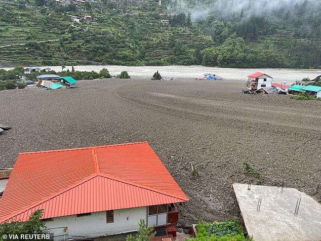 Terrifying moment village is washed away by cloudburst flash flood in India, killing multiple people