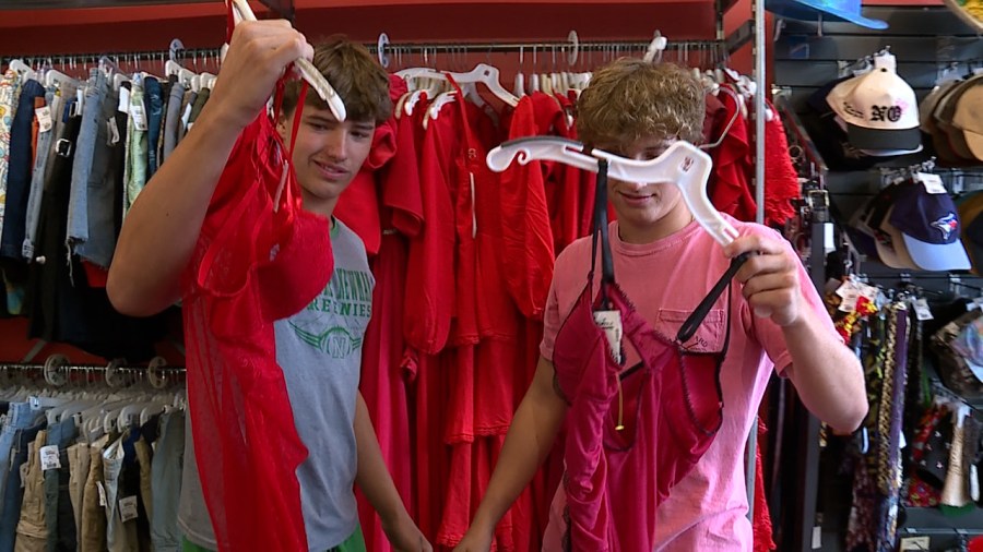 Football players picking out their dresses for Red Dress Run in New Orleans