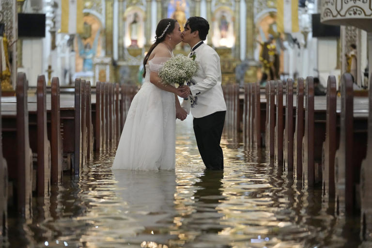 'An extraordinary wedding': Couple tie the knot in a flooded church amid typhoon in the Philippines