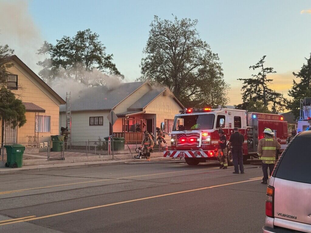 Firefighters knocking down attic fire in C Street house