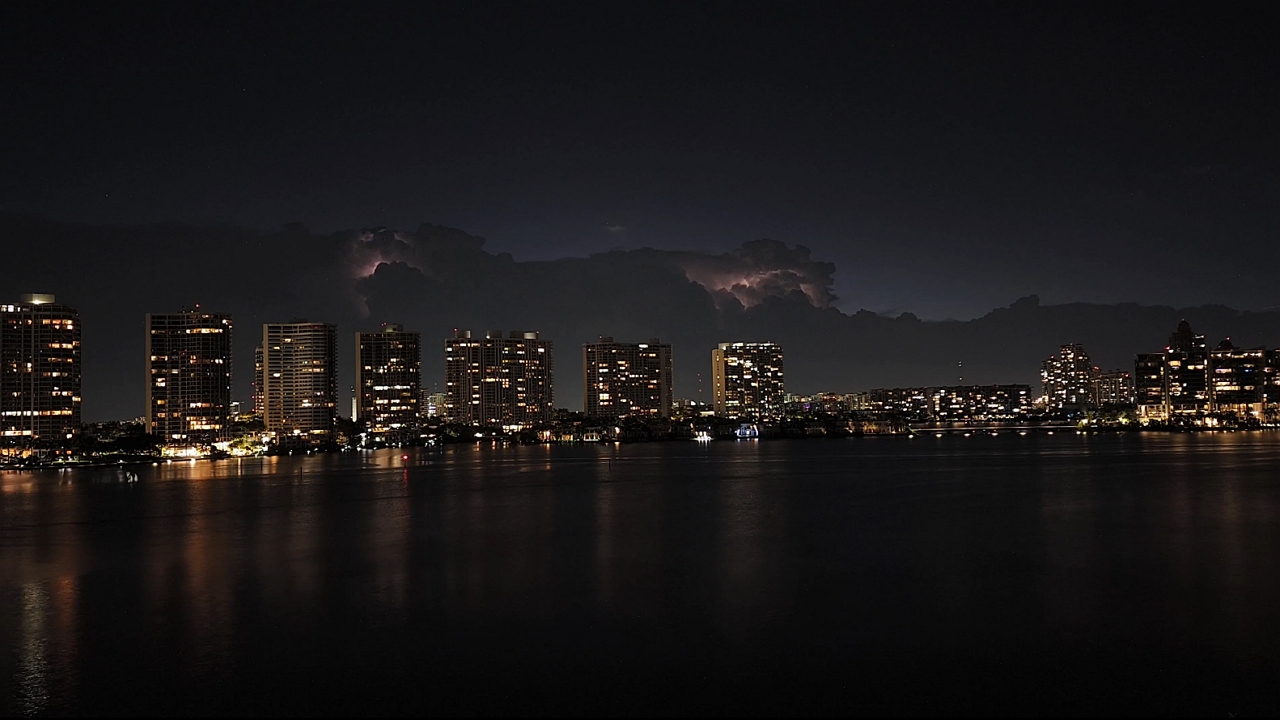 Lightning strikes illuminate dark clouds in time-lapse over Sunny Isles ...