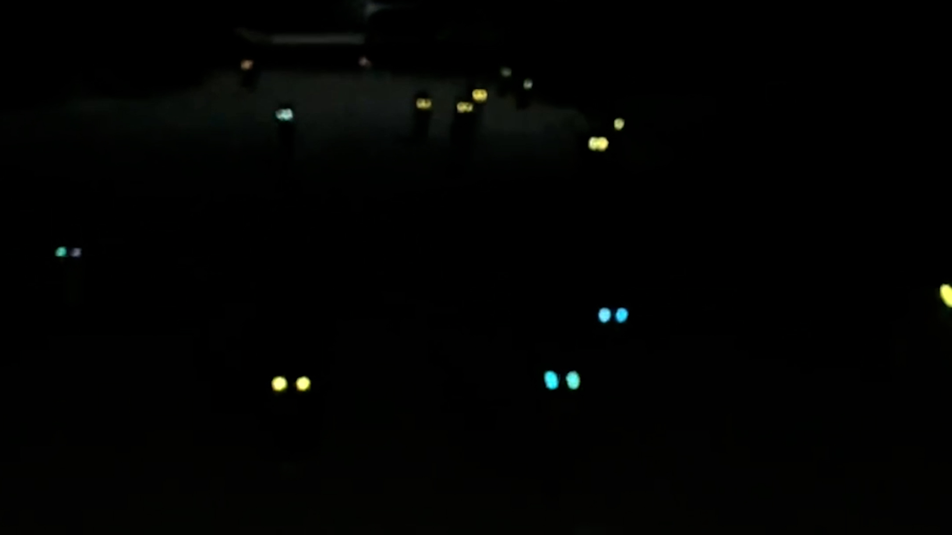Glowing-eyed cats burst from darkness in eerie swarm