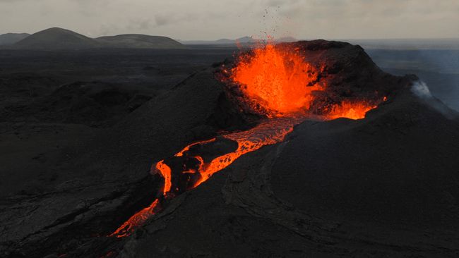 Fast-Flowing Lava Glows Against Stark Icelandic Backdrop