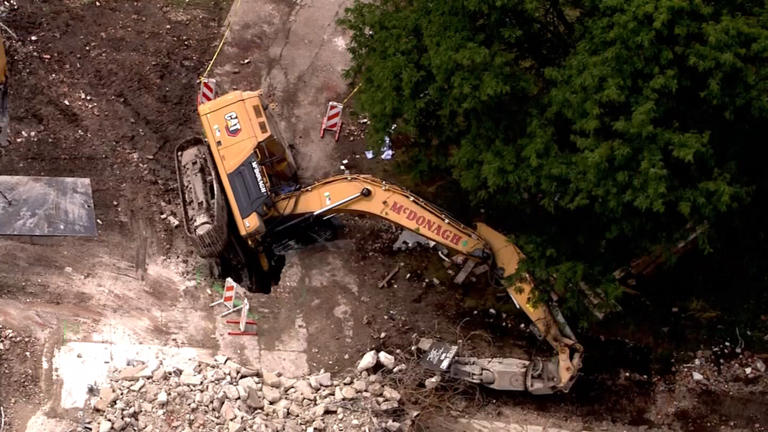 Person ‘extricated' after being trapped inside fallen crane during ...