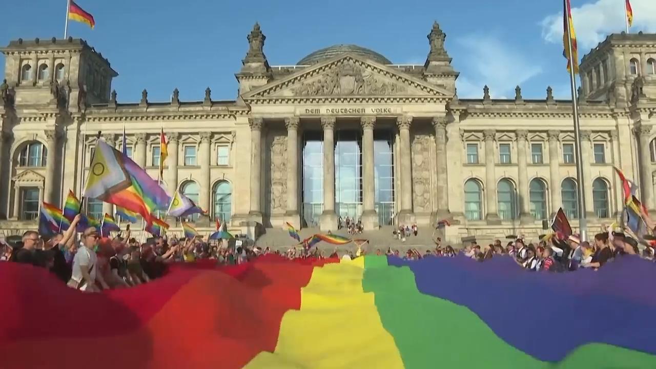 LGBTQ+ community unfurls rainbow flag in front of the German parliament