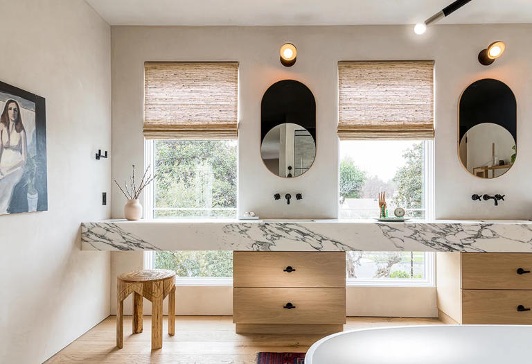 8 Bathroom Mirror Workarounds for When There’s a Window in Your Way