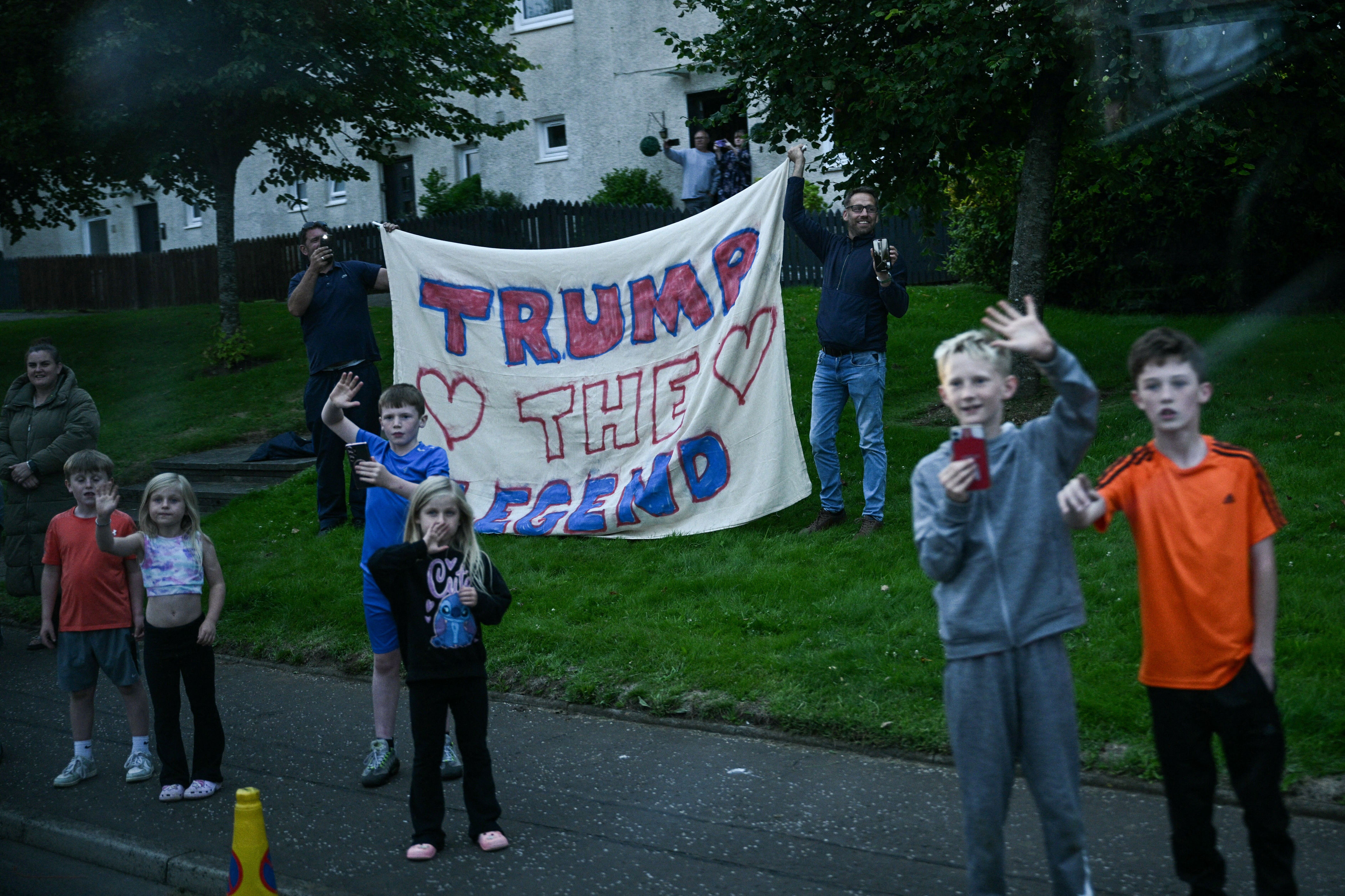 Photos: Protesters rally with bagpipes and pointed signs as Trump ...
