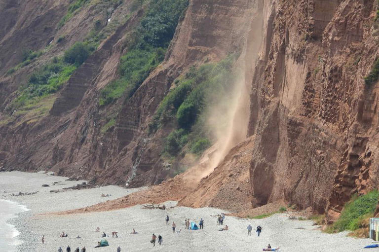 Sunbathers left stranded after cliff comes crashing on Devon beach