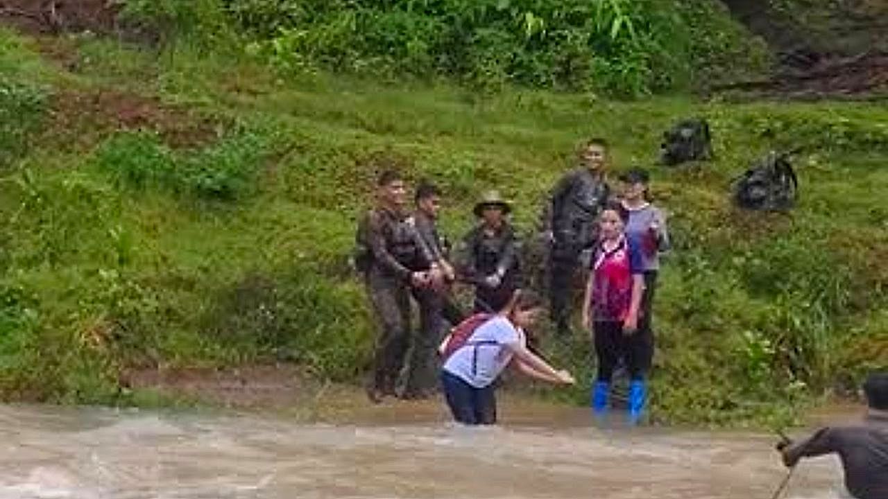 Teachers and locals brave raging river amid typhoon Wipha evacuation