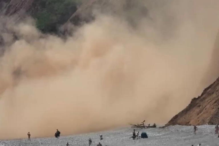 Sunbathers left stranded after cliff comes crashing on Devon beach