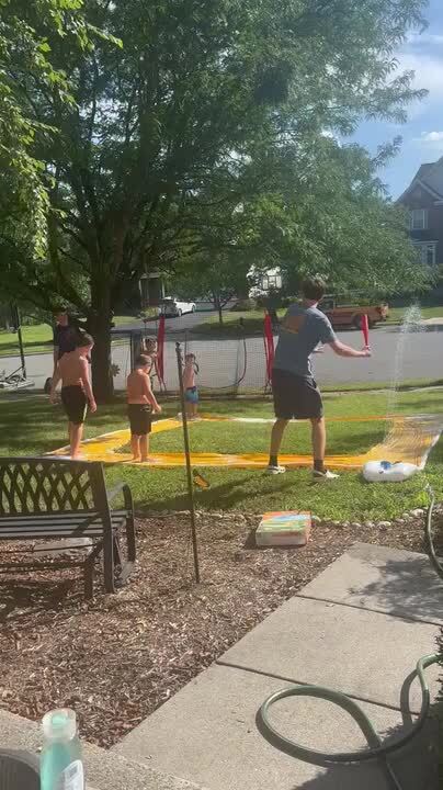Boy Accidentally Hits Kid in Head While Playing Slip and Slide Baseball