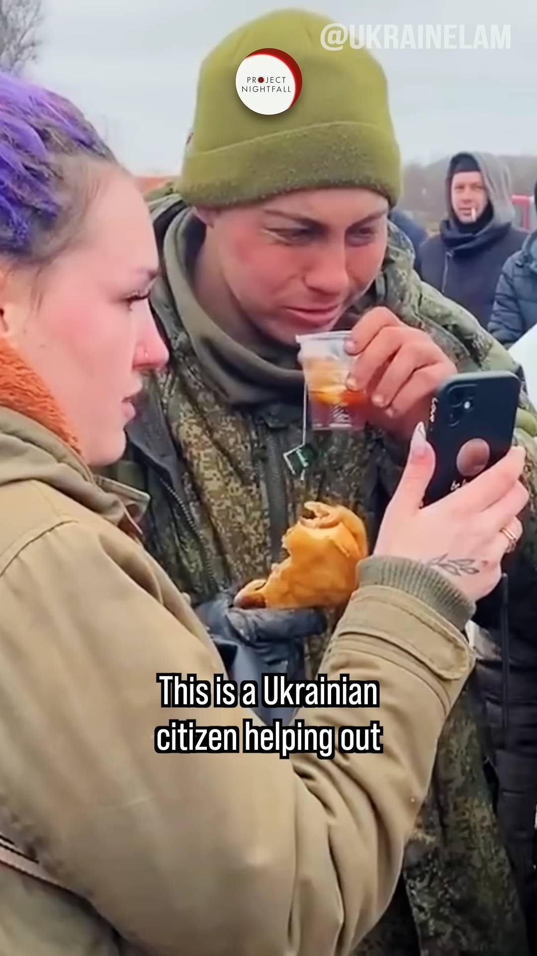 Ukrainian woman helps a crying Russian soldier