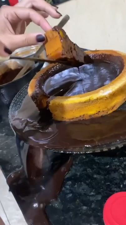 Chocolate Spills as Person Tries to Pull Out Piece of Cake