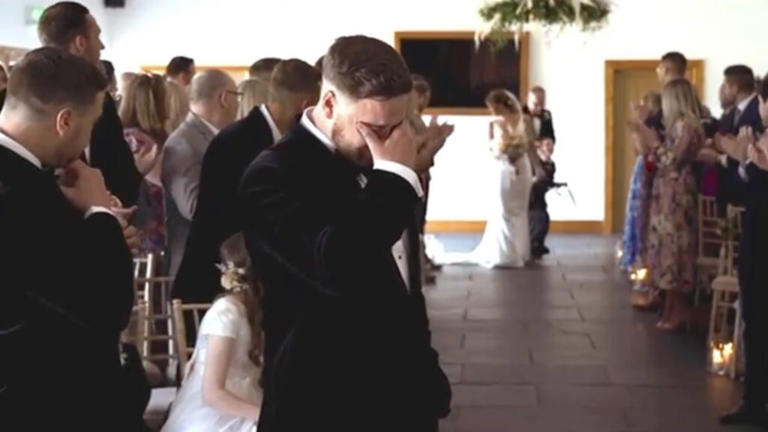 Boy defies odds to walk mum down aisle with special harness