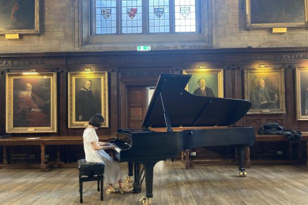Nine-year-old preparing for solo piano performance after achieving diploma