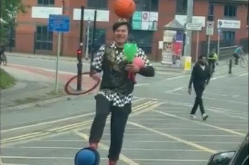 Moment clown baffles Leeds drivers as he performs at busy traffic lights