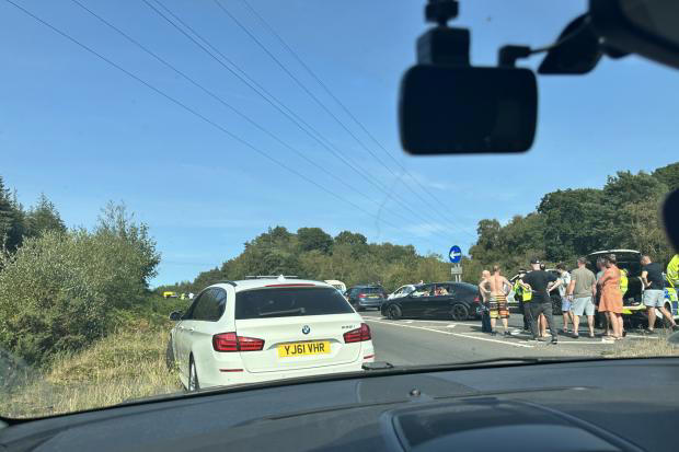 Main A-road closed as vehicle fire spreads across heath land