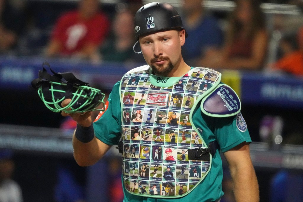 Mariners’ Cal Raleigh signs bathroom item, dons custom chest protector ...